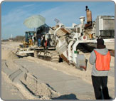 Image of workers completing beach restoration after disaster